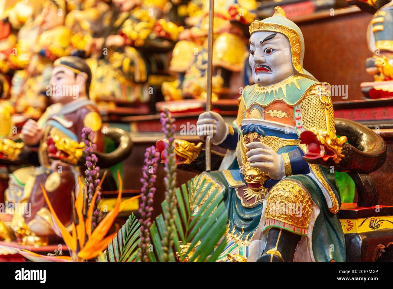 Collection of colorful Chinese statues placed on stone stairs in temple ...