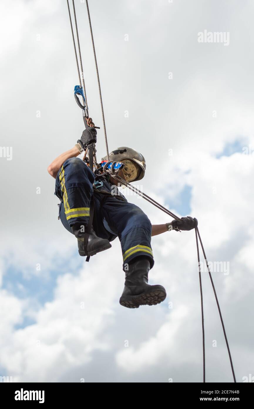 Side view of strong firefighter in protective equipment during training ...