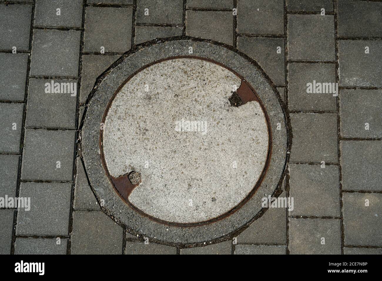 Top view of a metal sewer manhole on street ground Stock Photo - Alamy
