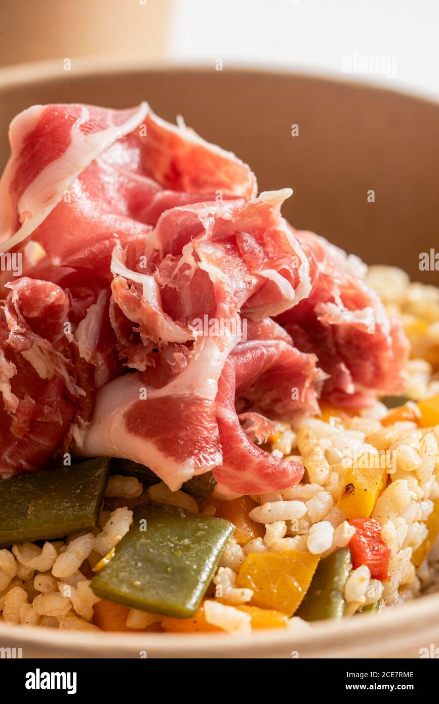 Closeup of tasty rice with various vegetables garnished with Iberico ...