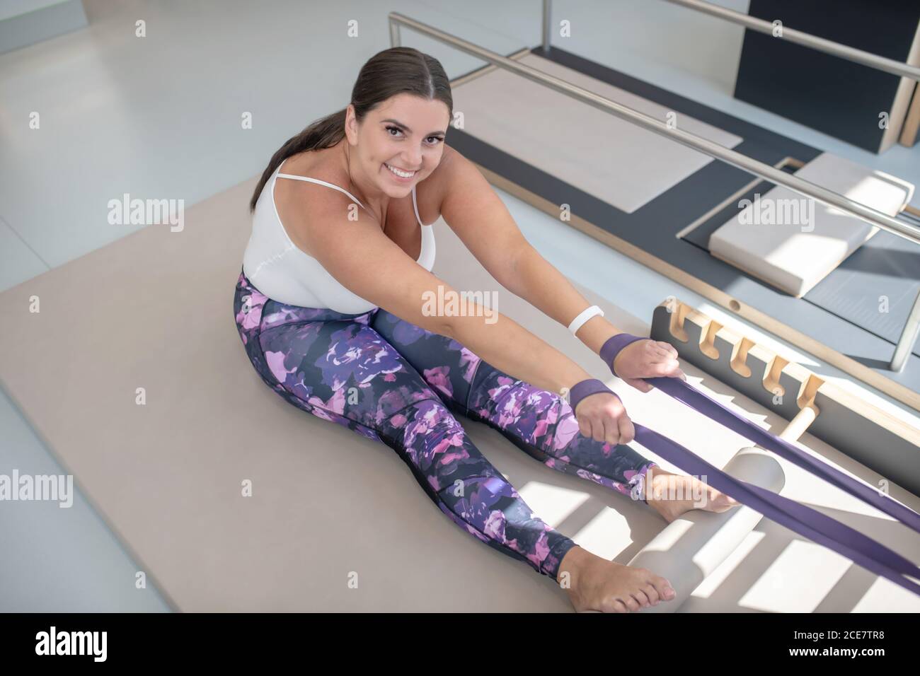 Young woman doing stretching exercises at home Stock Photo - Alamy