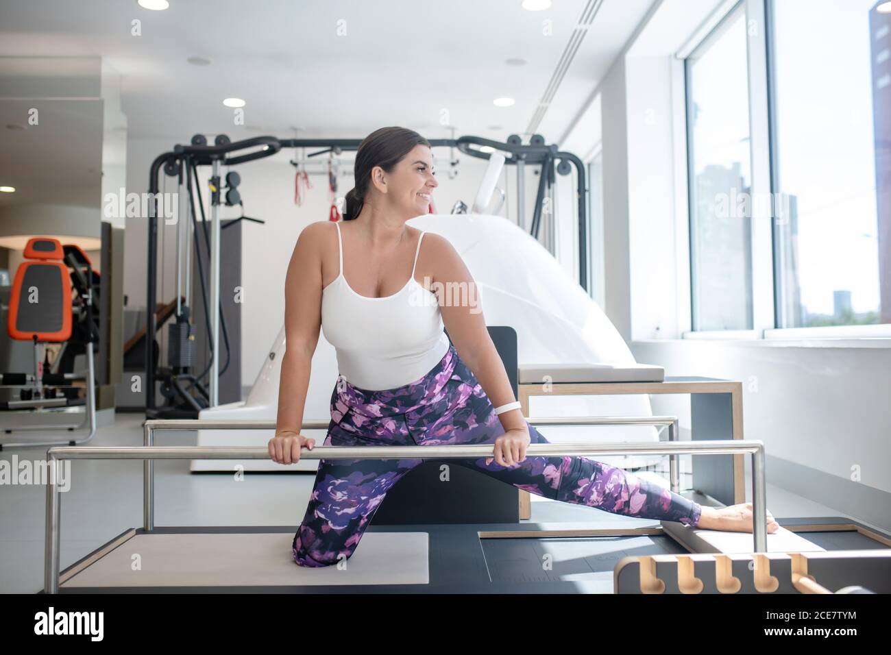 Woman stretching her hamstrings while doing exercises Stock Photo - Alamy
