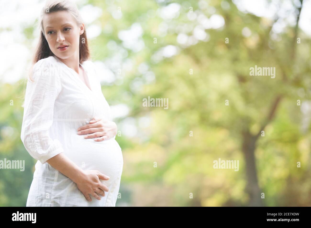 Expecting woman in nature Stock Photo - Alamy