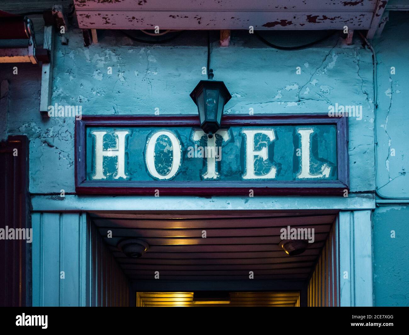 Rectangular blue signage with word hotel written with white letters and ...