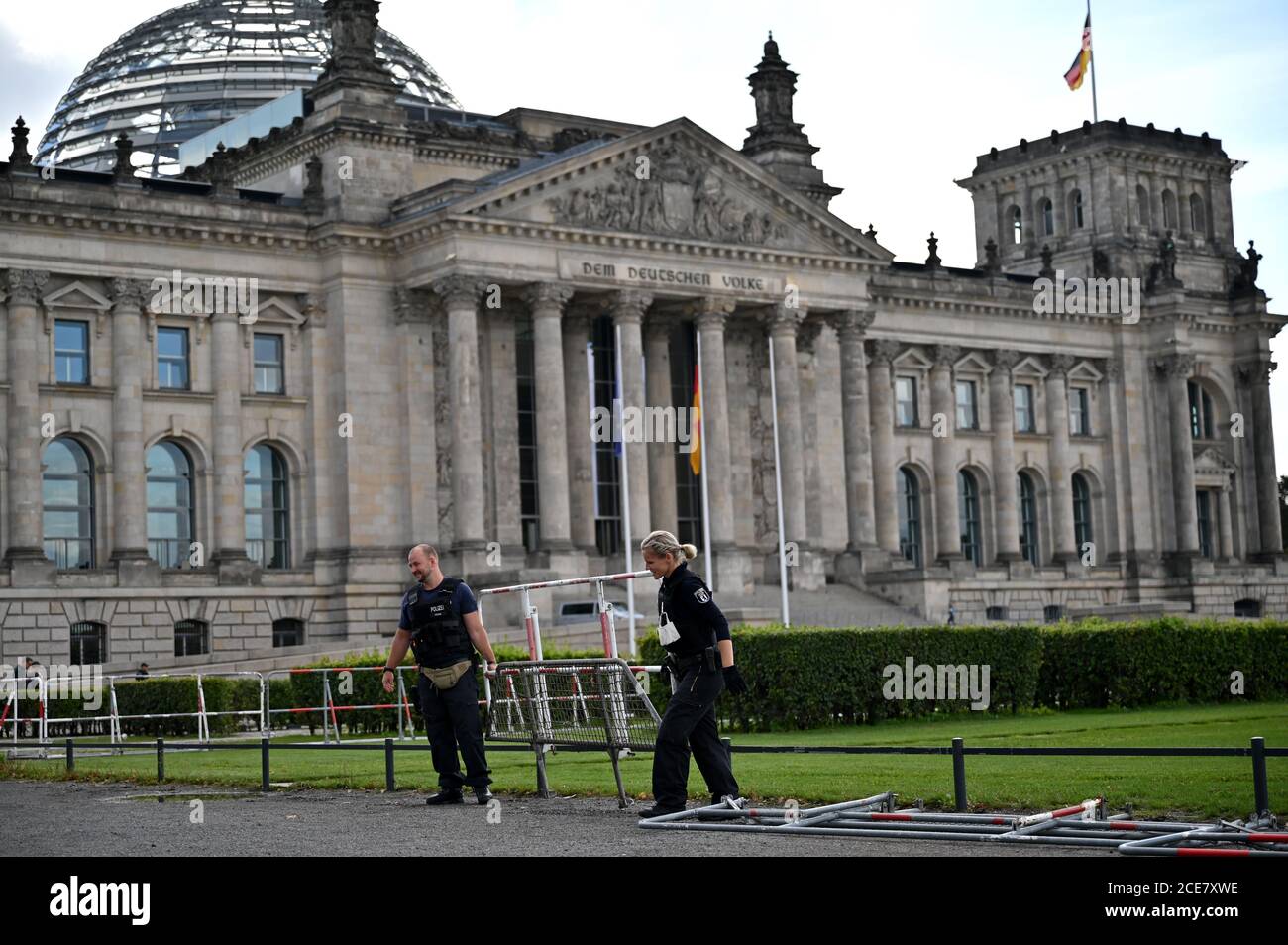 Berlin, Germany. 31st Aug, 2020. A policeman and a policewoman carry ...