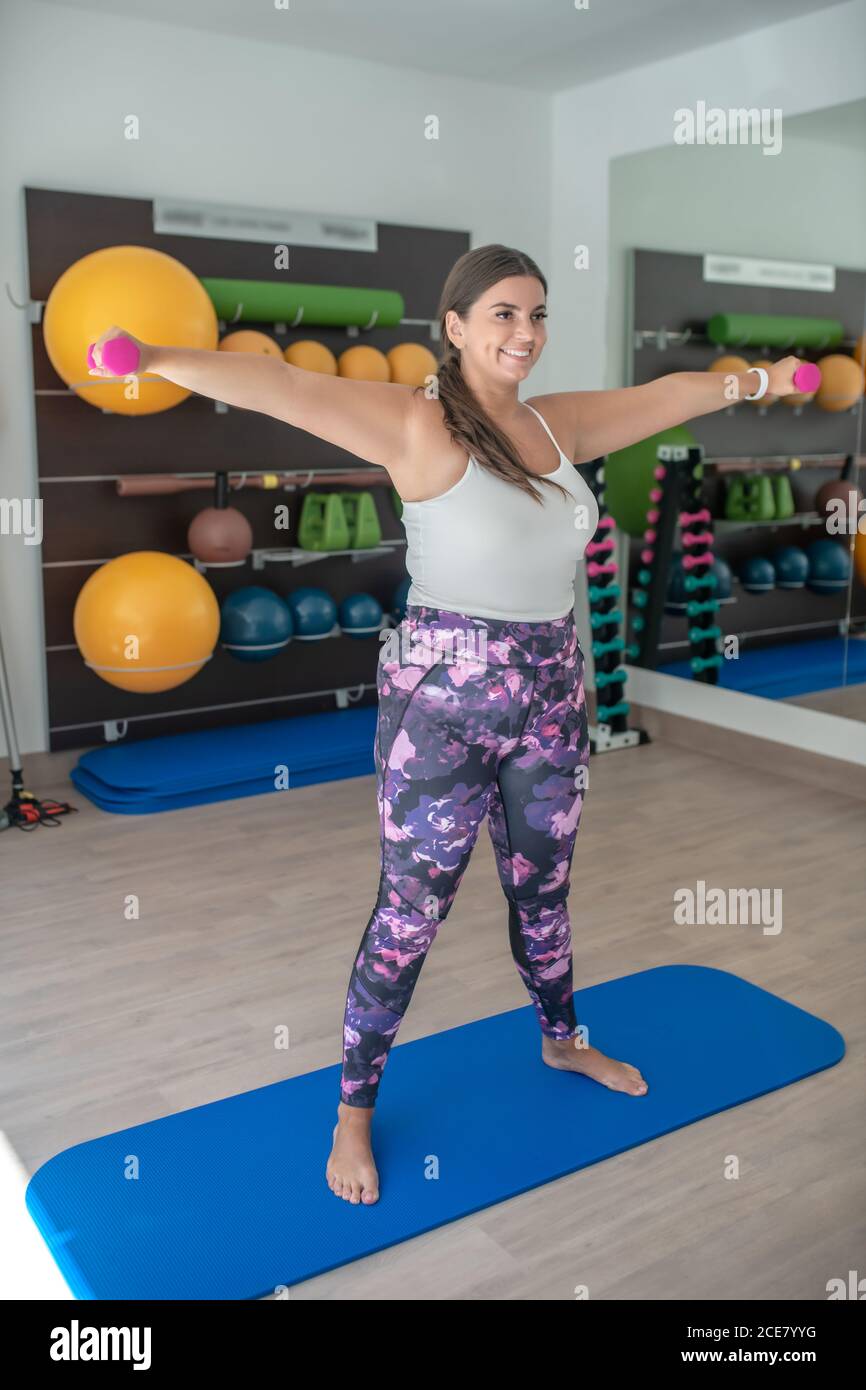 Plus-sized woman practising yoga asanas in a gym Stock Photo - Alamy