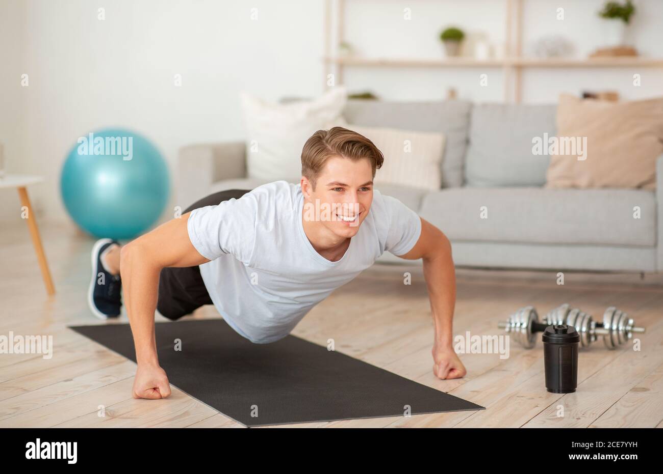 Quarantine sport. Muscular guy doing push-up exercises on fists Stock ...