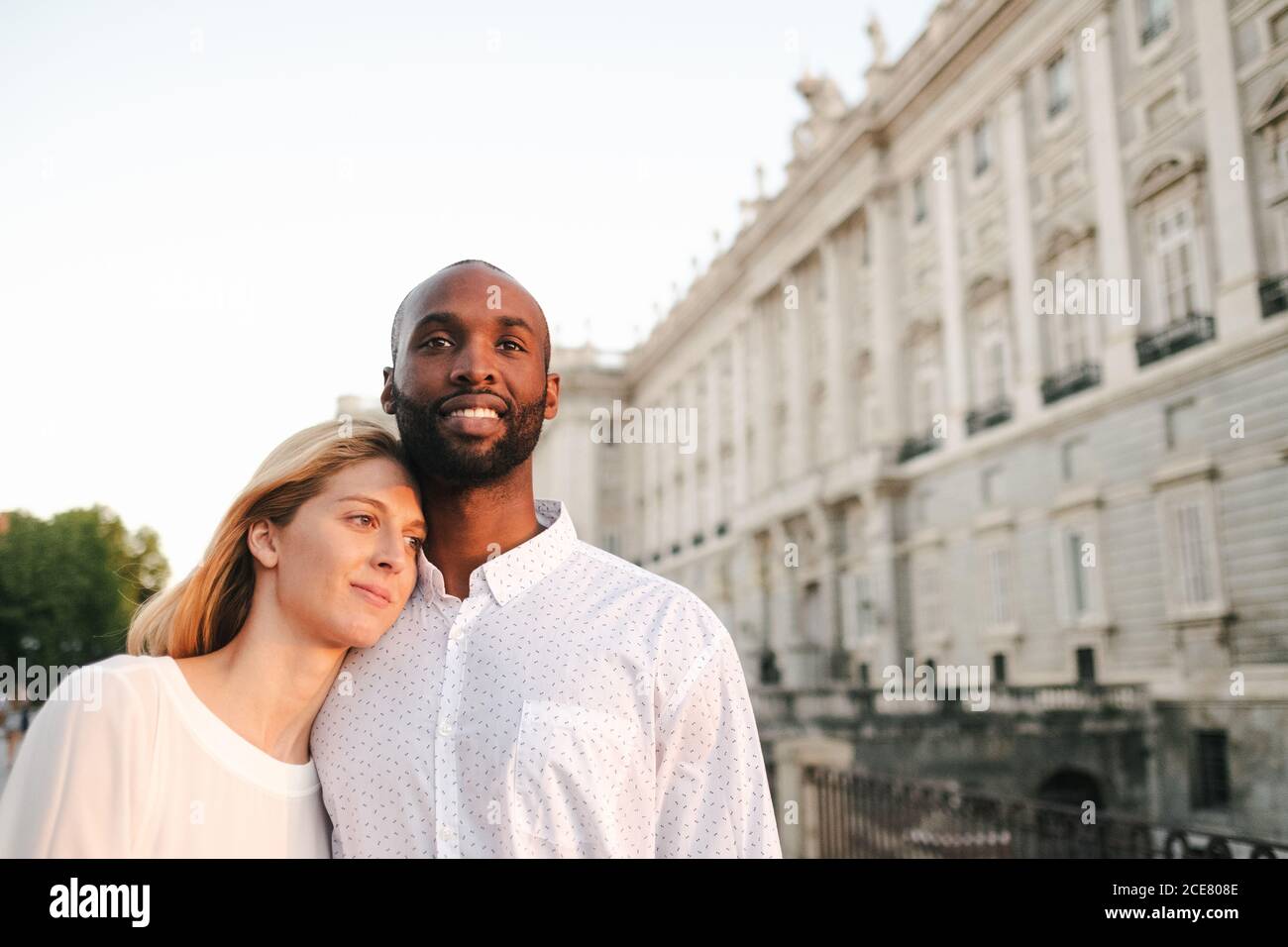 Content black boyfriend and smiling girlfriend while bonding sensually ...