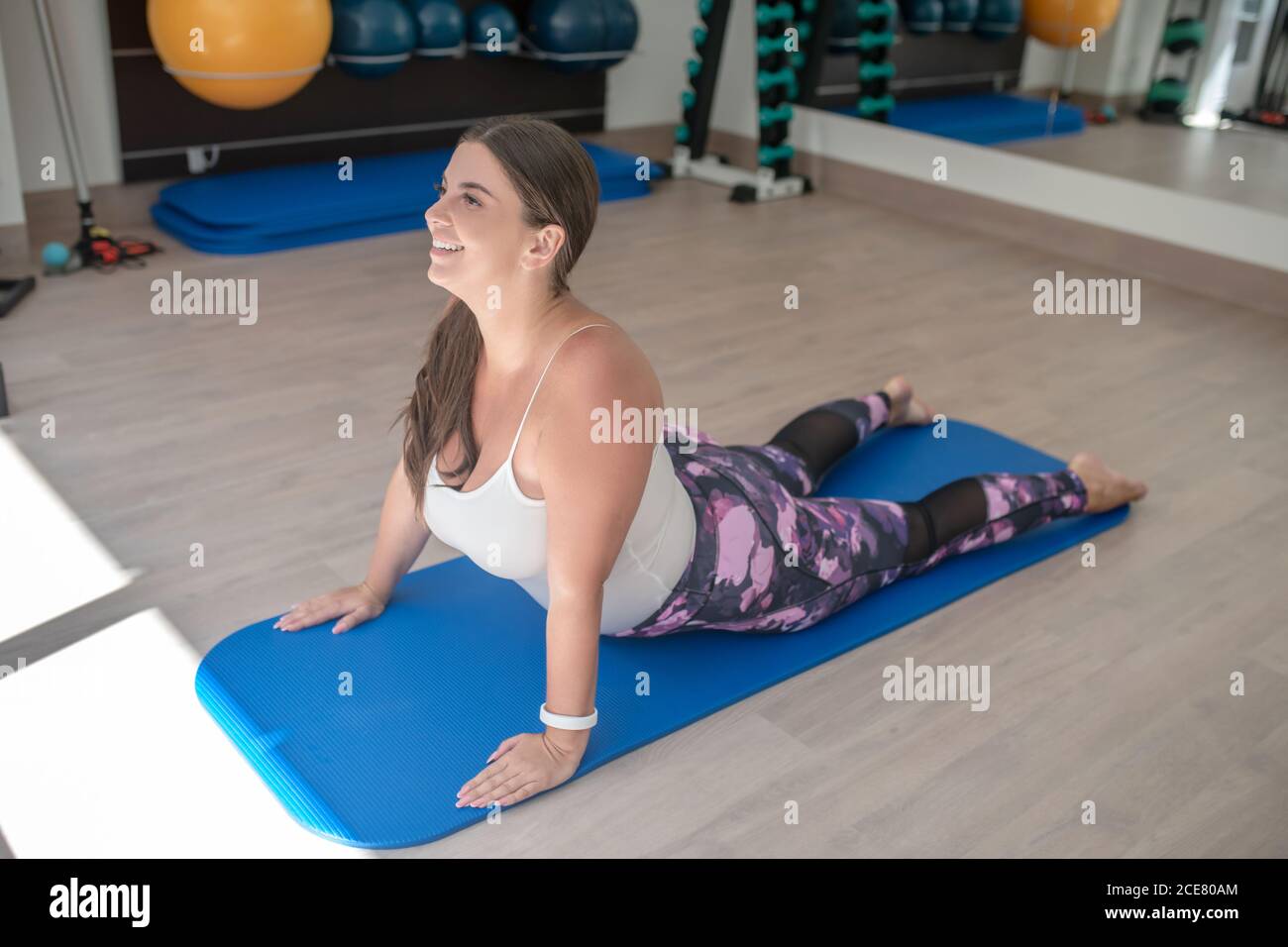 Woman stretching her back muscles during the training Stock Photo - Alamy