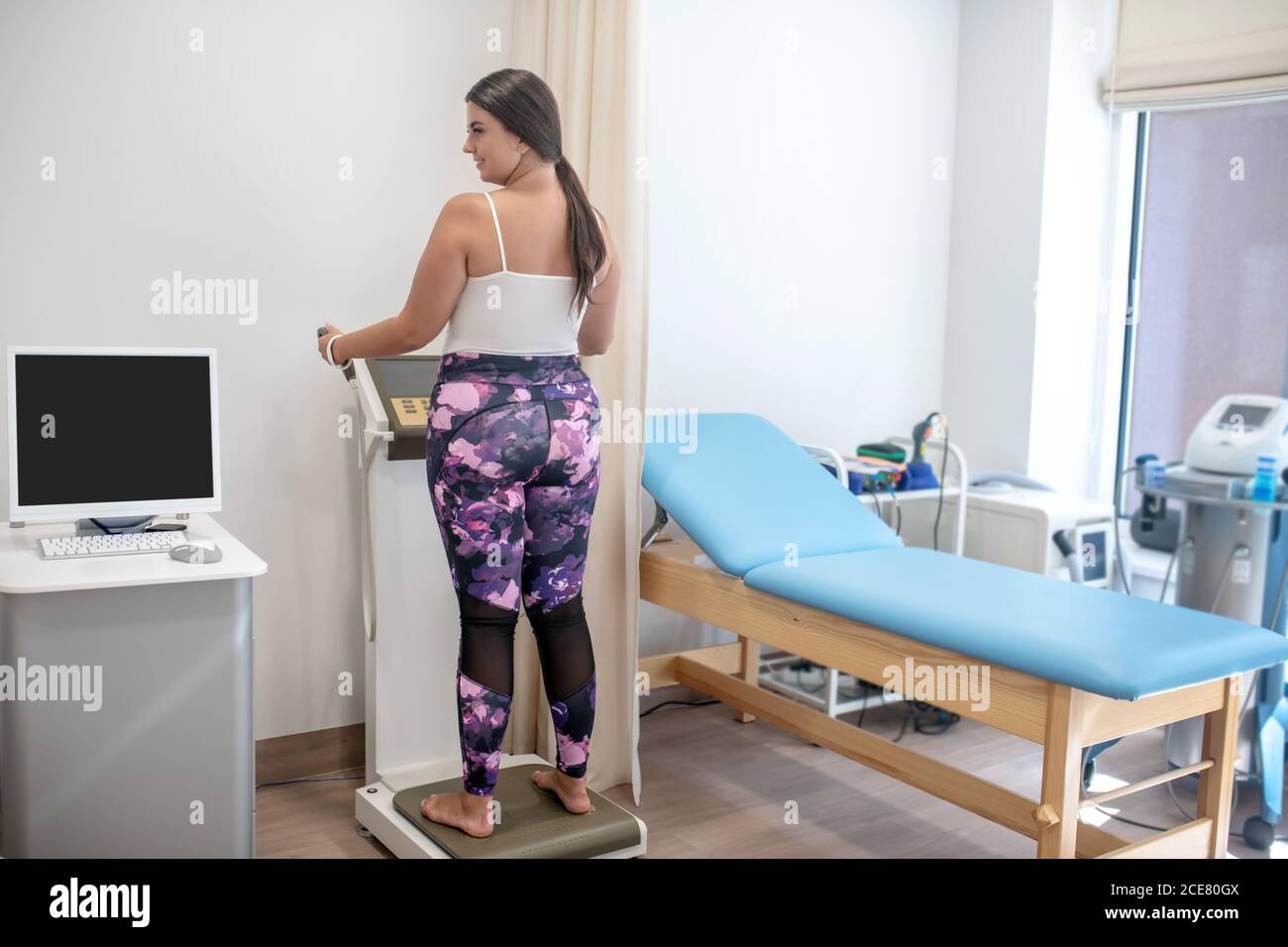 Woman measuring her health parameters in a clinic Stock Photo - Alamy