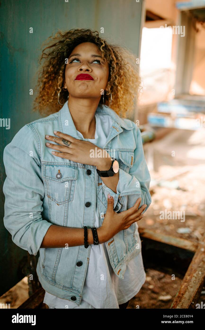 Funky African American female millennial in denim clothes standing in ...