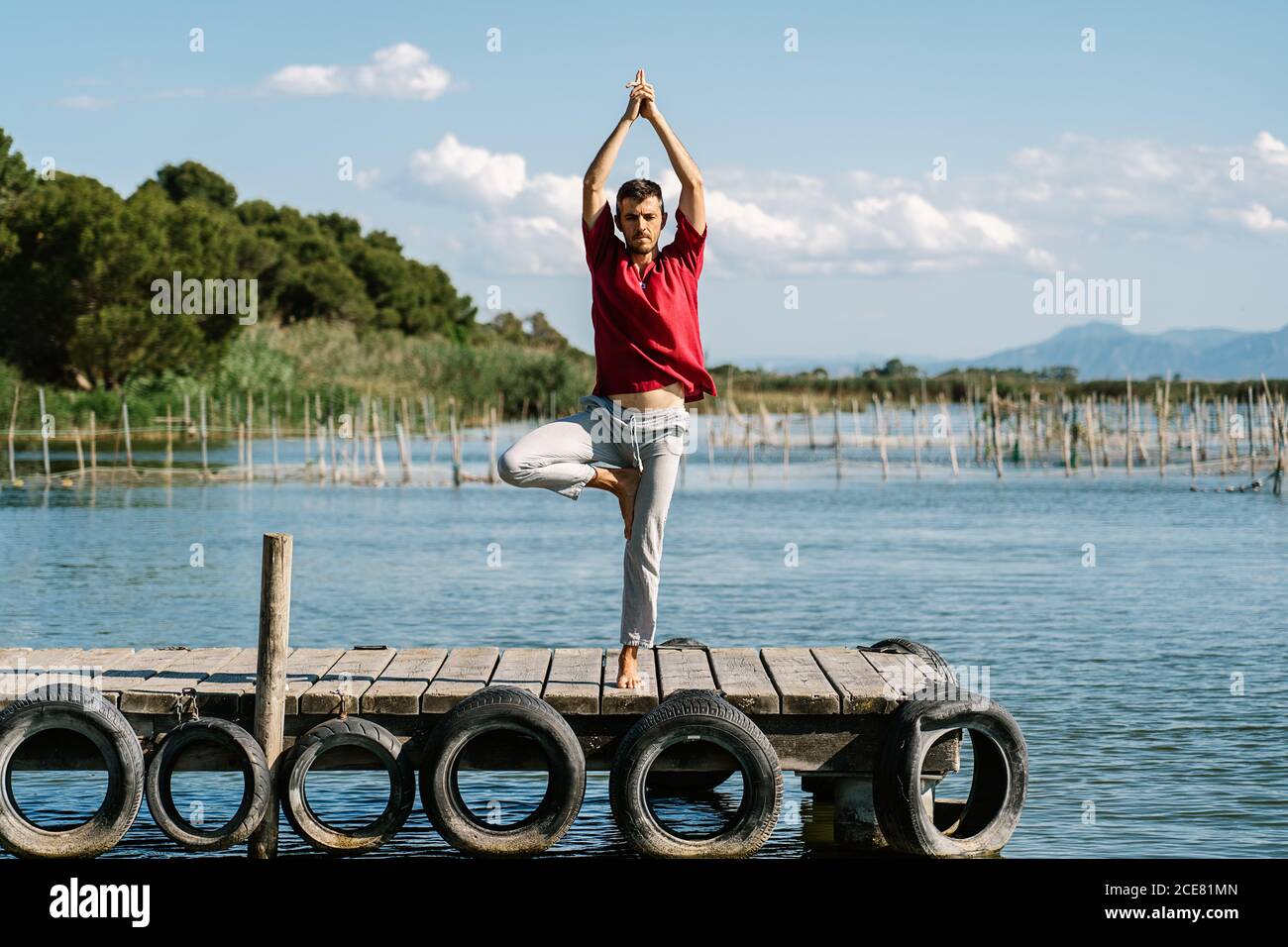 Full body of peaceful barefooted guy in casual wear performing Lord of ...