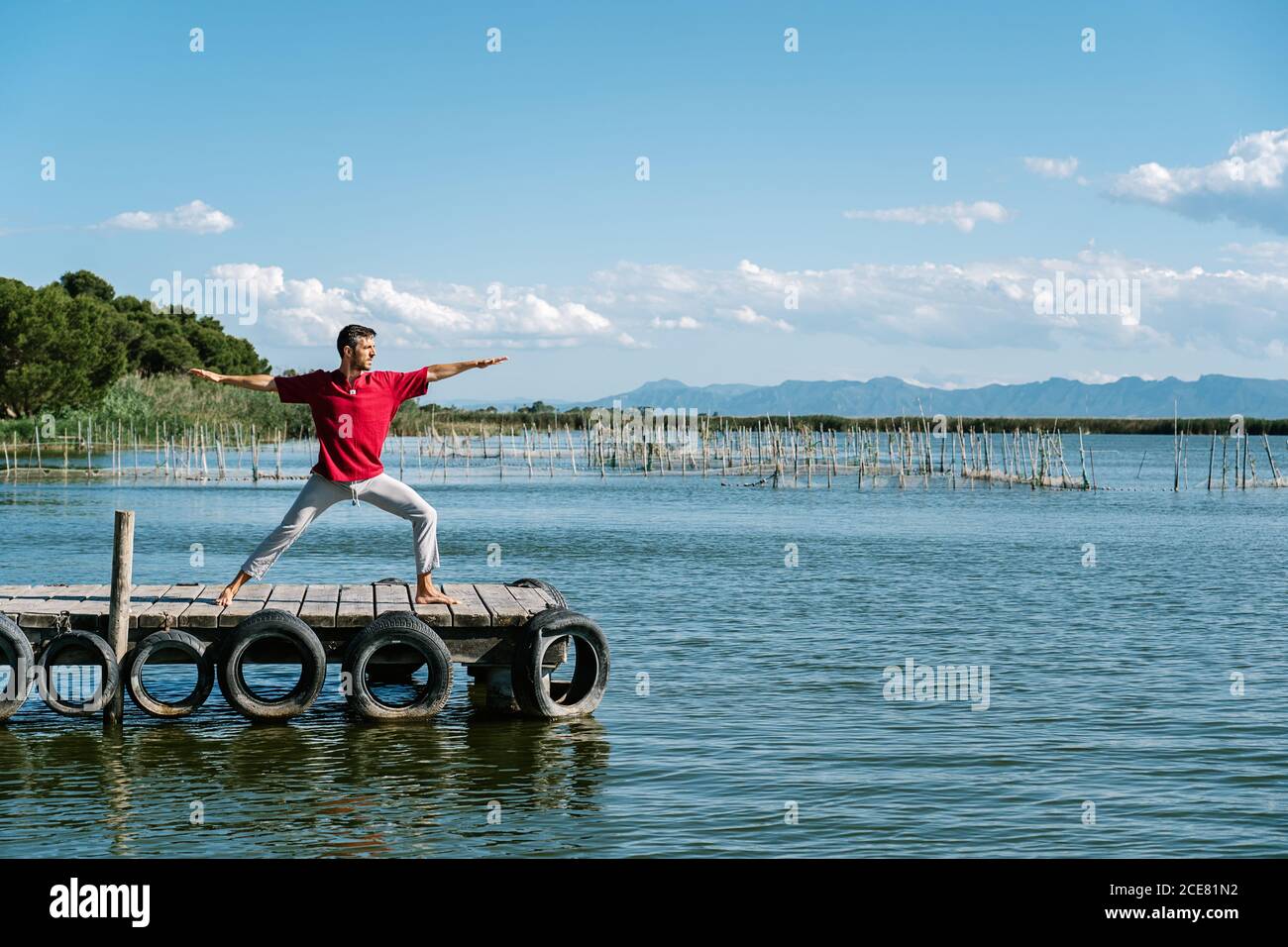 Full body of peaceful barefooted guy in casual wear performing Lord of ...