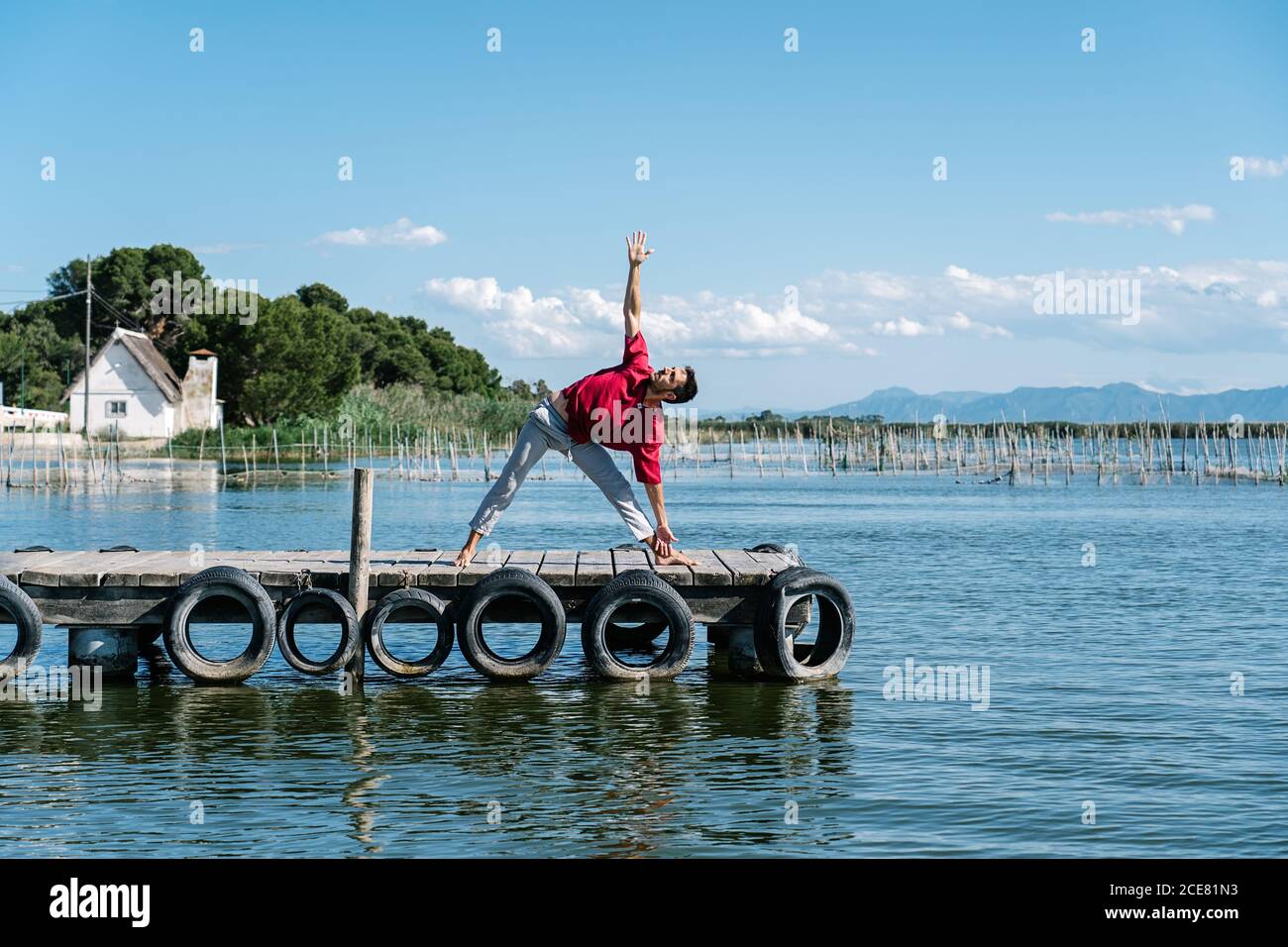 Full body of peaceful barefooted guy in casual wear performing Lord of ...