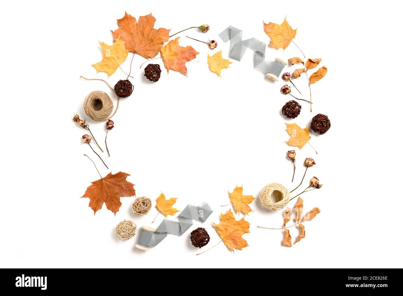 Frame made from dry leaves and roses, rattan balls, ribbons, twine on ...