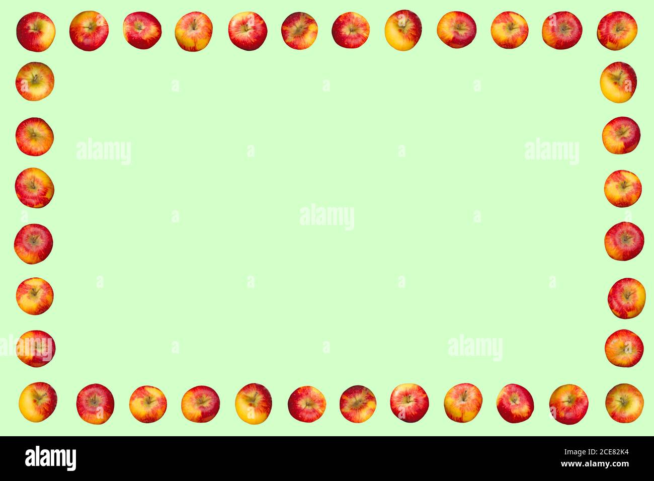 Frame of apples isolated on a green background Stock Photo - Alamy