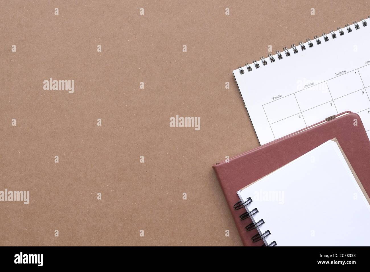 Notepads and calendar on brown color desk. Top view. Copy space Stock ...