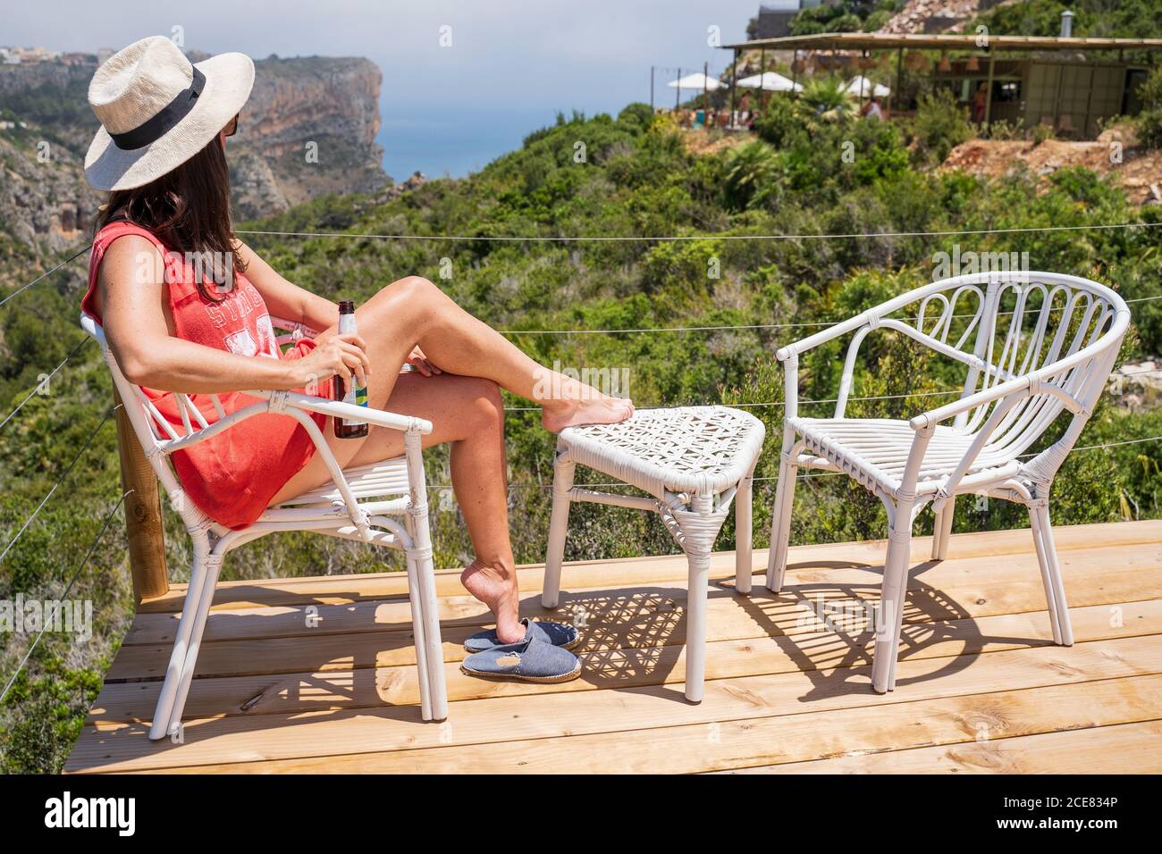 Side view full body faceless relaxed female in hat sitting gracefully ...