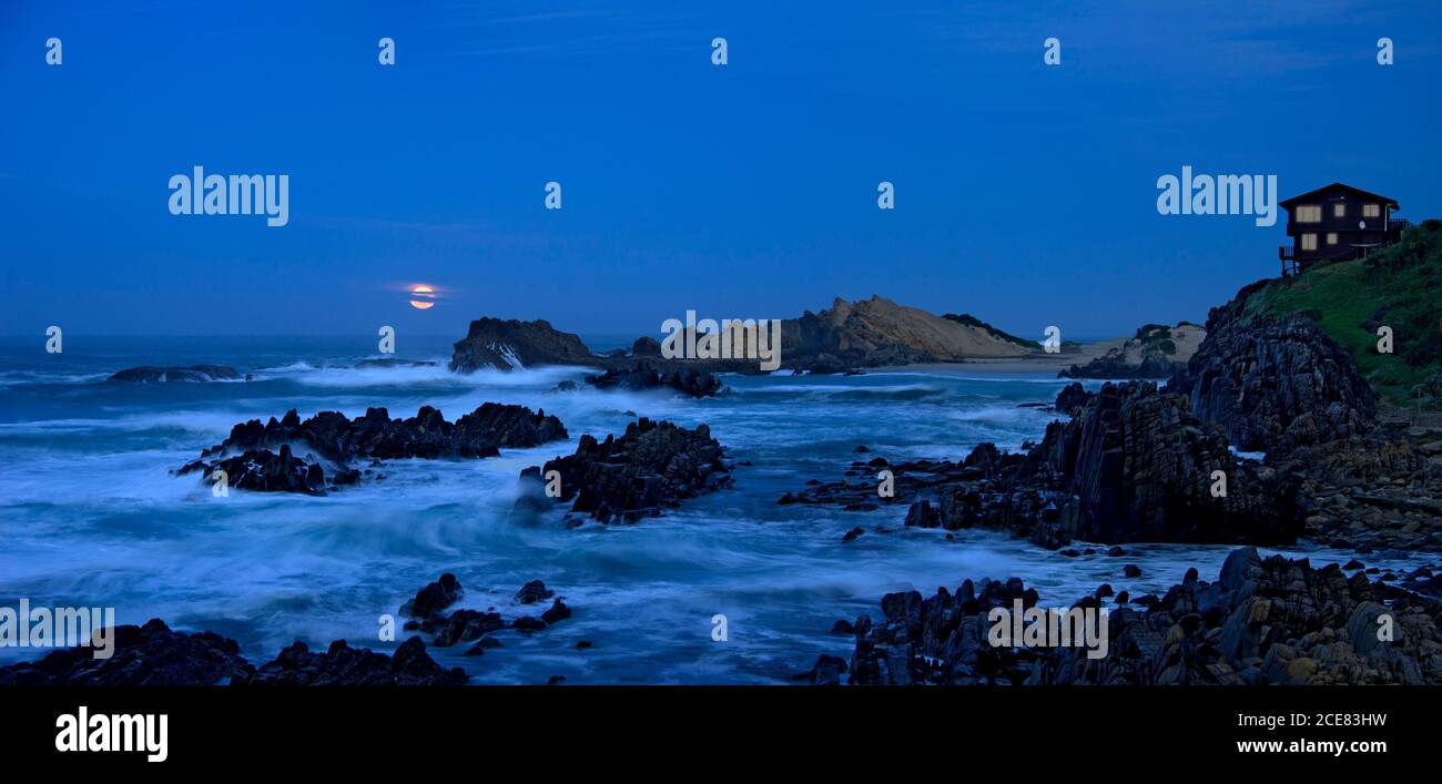 Full moon setting Stock Photo - Alamy