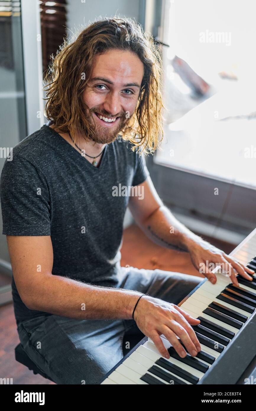 Smiling man playing synthesizer hi-res stock photography and images - Alamy