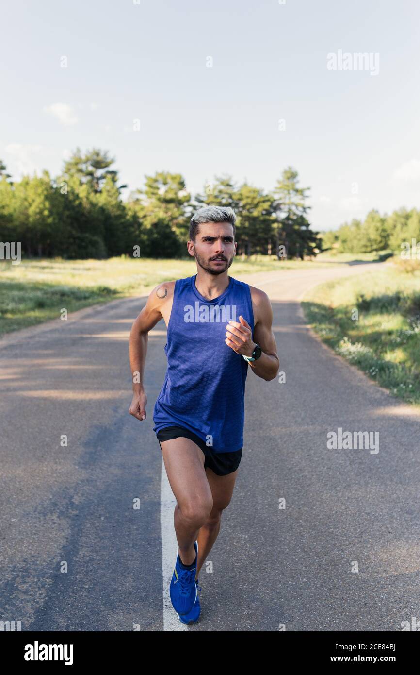 Full length of man running on road hi-res stock photography and images ...