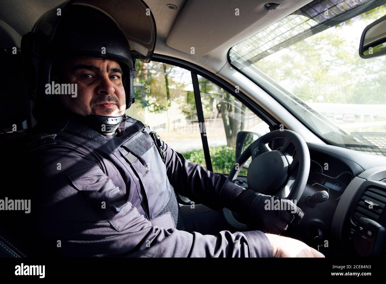 Side view of serious plump middle aged police officer in uniform and ...