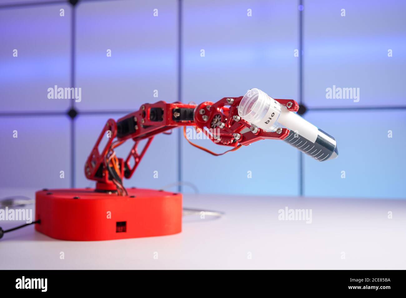 Robot arm with test tube with biological sample in science laboratory ...