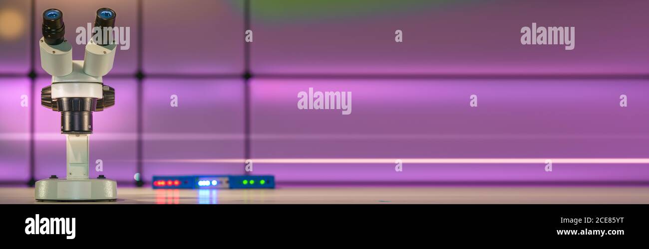 Banner with a microscope on a table in a science lab Stock Photo - Alamy