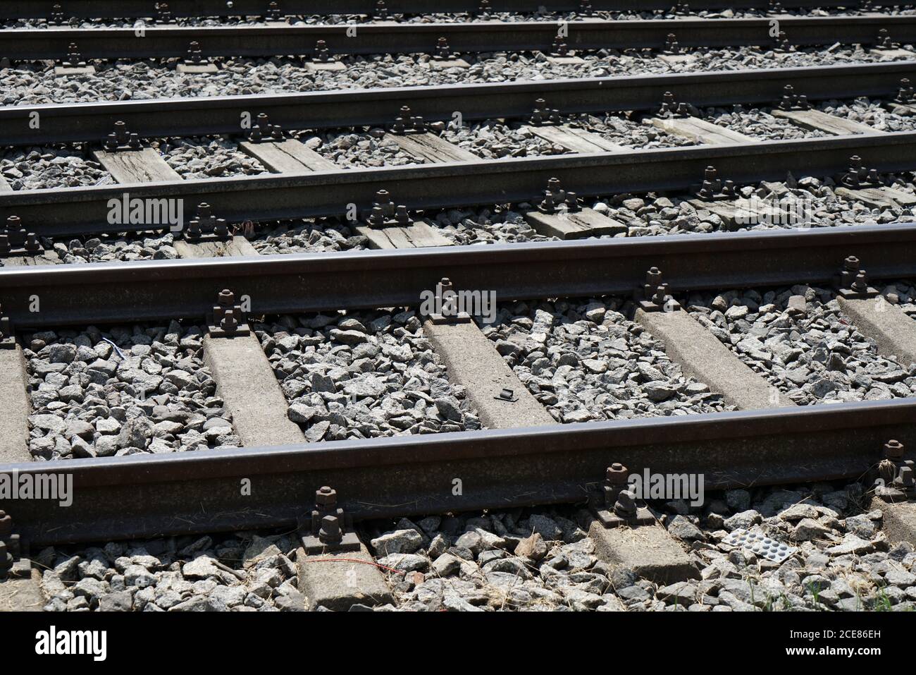 Closeup shot of steel rails and pebbles Stock Photo - Alamy