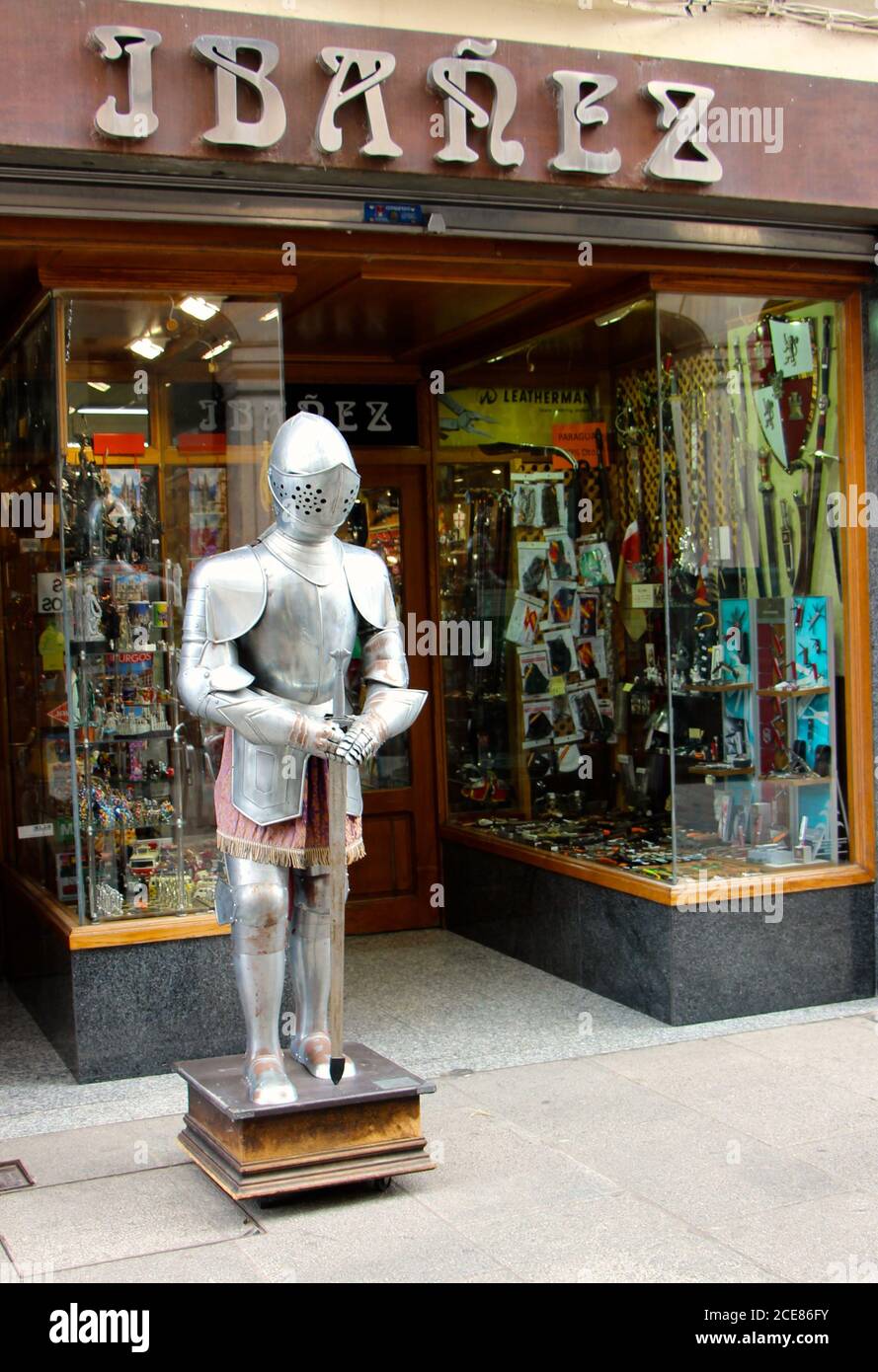 Knight in armour outside a shop selling hunting equipment and novelty ...