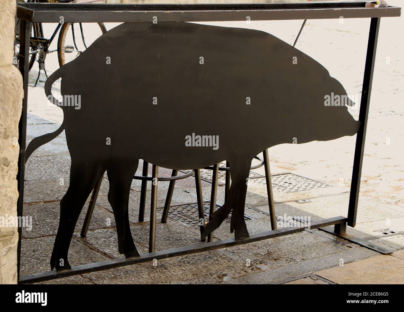 Shelf supported by a black flat metal pig silhouette shape outside a ...