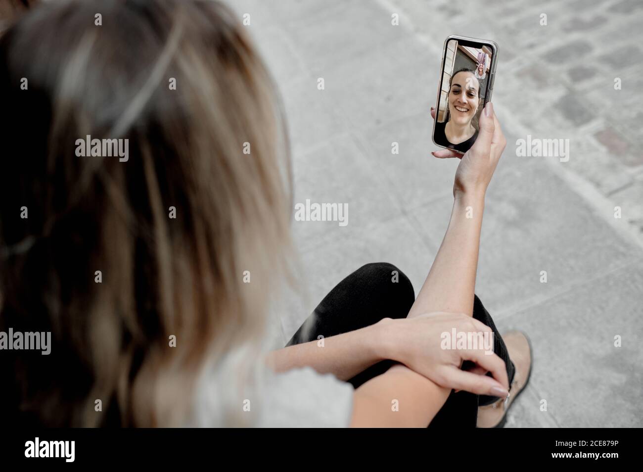 Side view of unrecognizable stylish female covering face with yellow ...