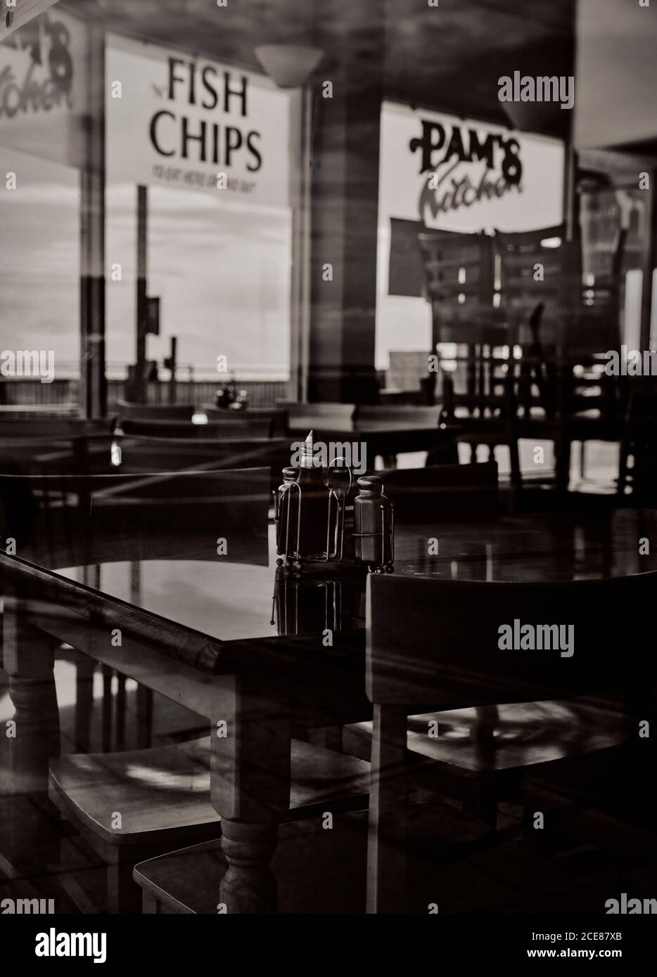 An interior and window of a closed English seaside fish and chips shop ...
