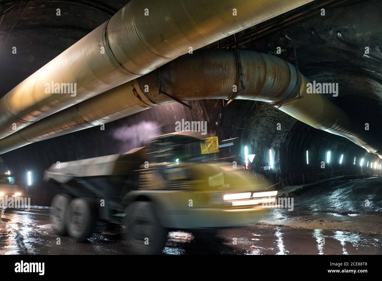 Blur tanker with headlights on driving on shiny asphalt road under big ...