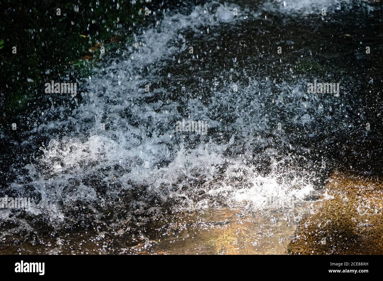 Macro shot of a rainfall splashing on the ground - perfect for ...