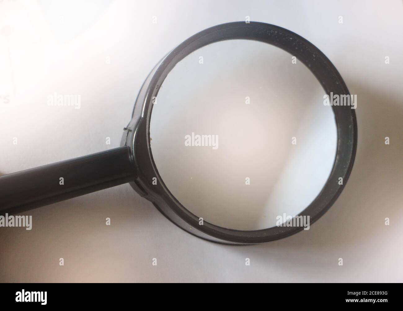 Business concept. Magnifying glass on paper background. Search and find ...