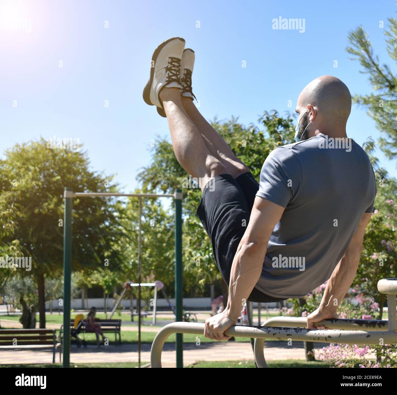 Fitness man doing calisthenics and street workout in a public park ...