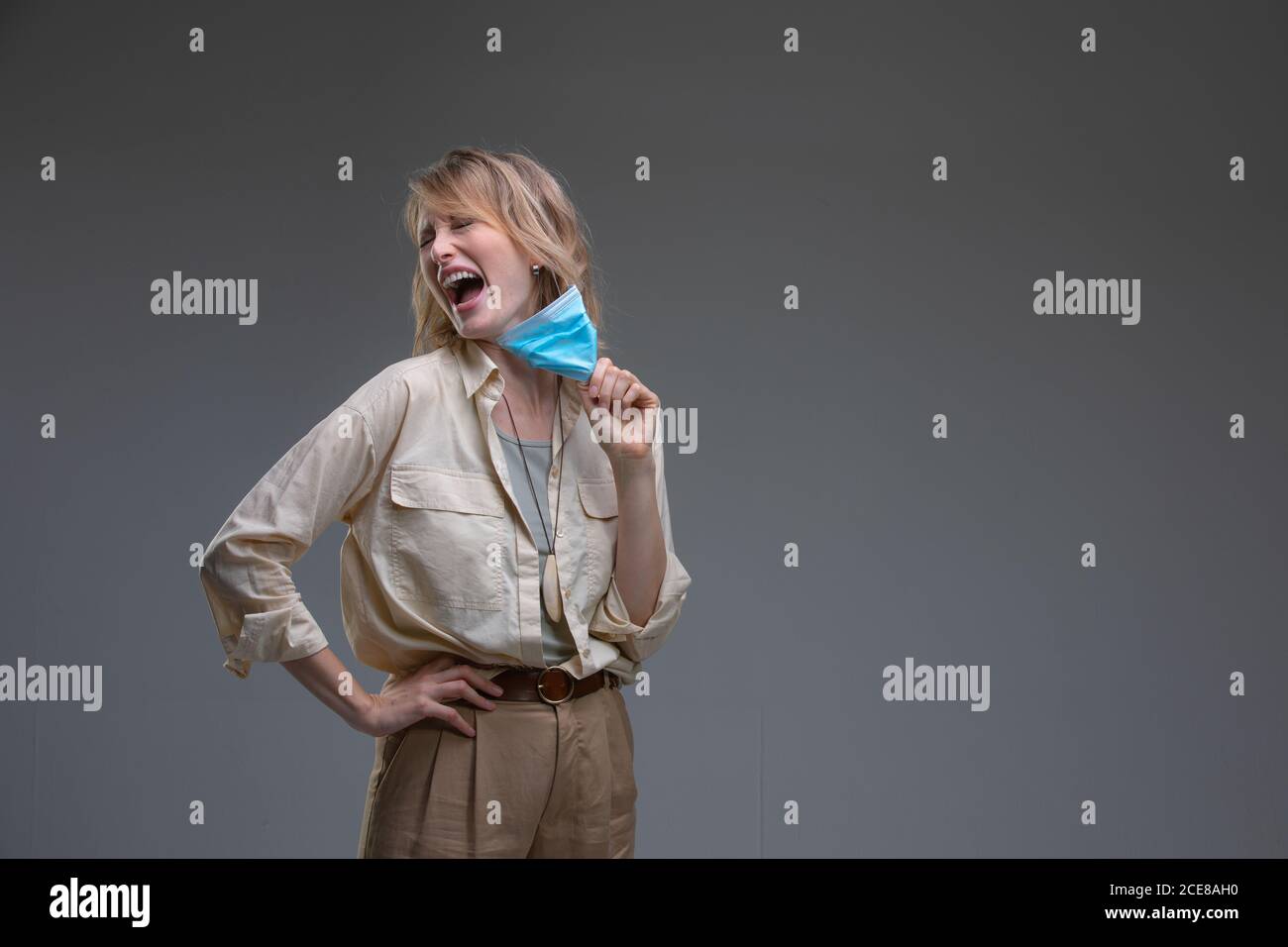Screaming Blond woman take off her surgical mask Stock Photo - Alamy