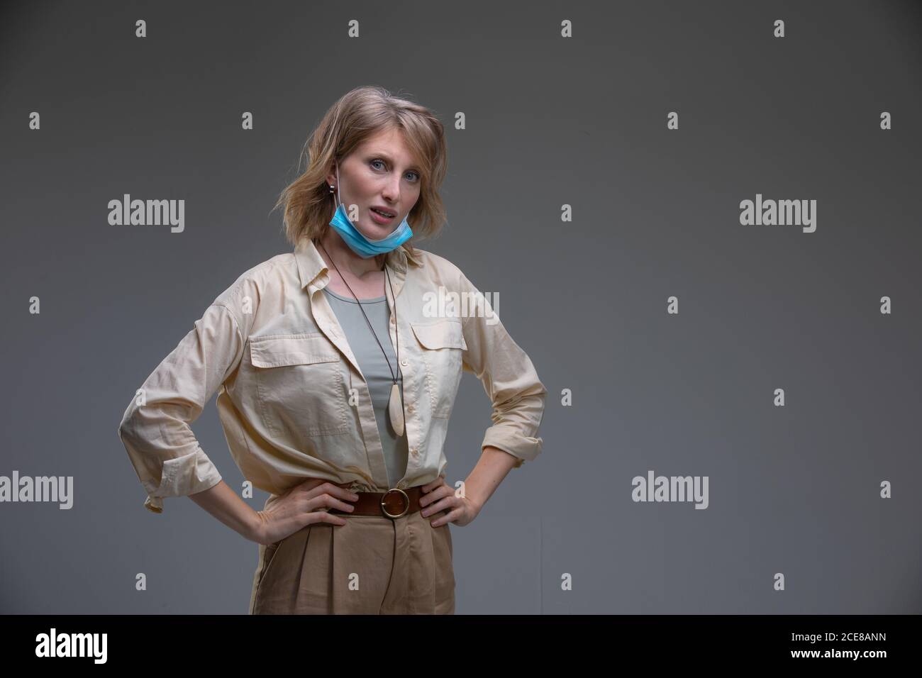 Blond woman take off her surgical mask Stock Photo - Alamy
