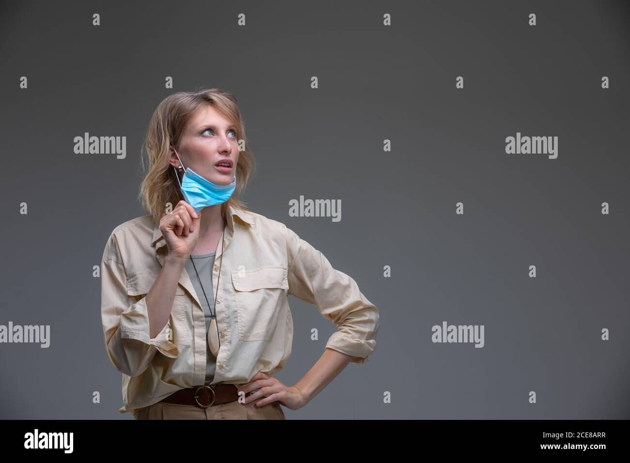 Blond woman take off her surgical mask Stock Photo - Alamy