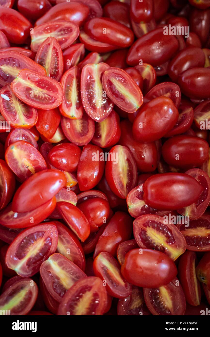Top view of heap of halves of fresh tomatoes placed on stall in local ...