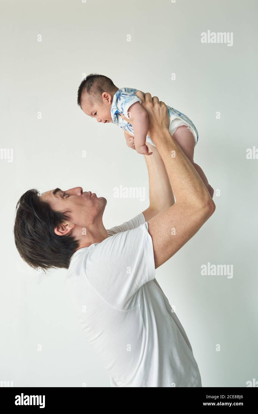 Dad lifting up his baby and having fun together Stock Photo - Alamy