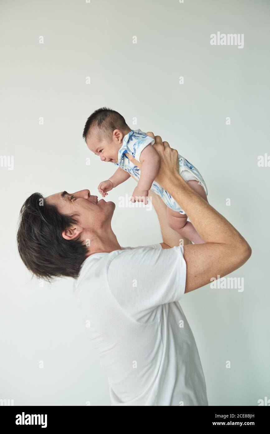 Dad lifting up his baby and having fun together Stock Photo - Alamy