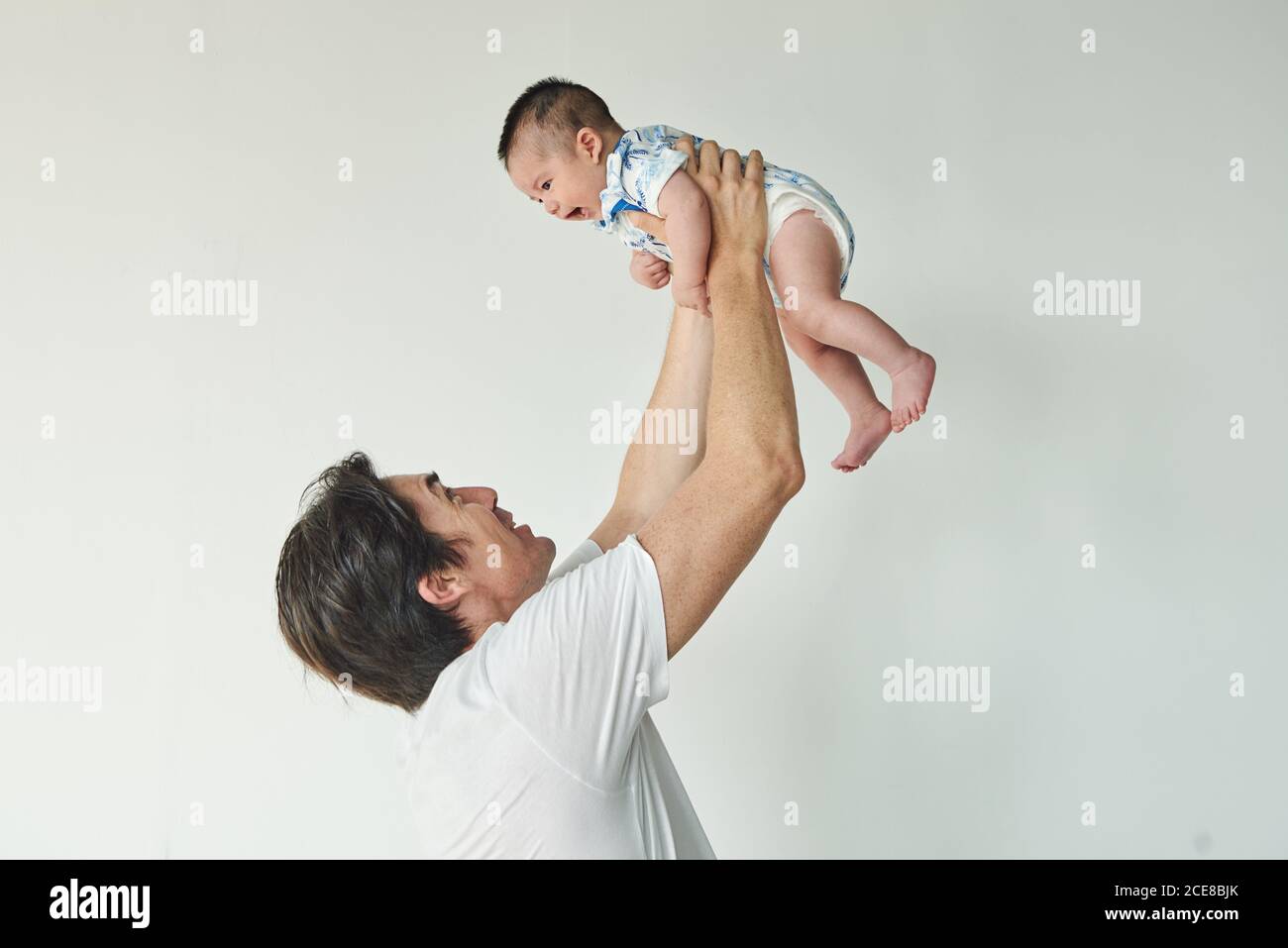 Dad lifting up his baby and having fun together Stock Photo - Alamy