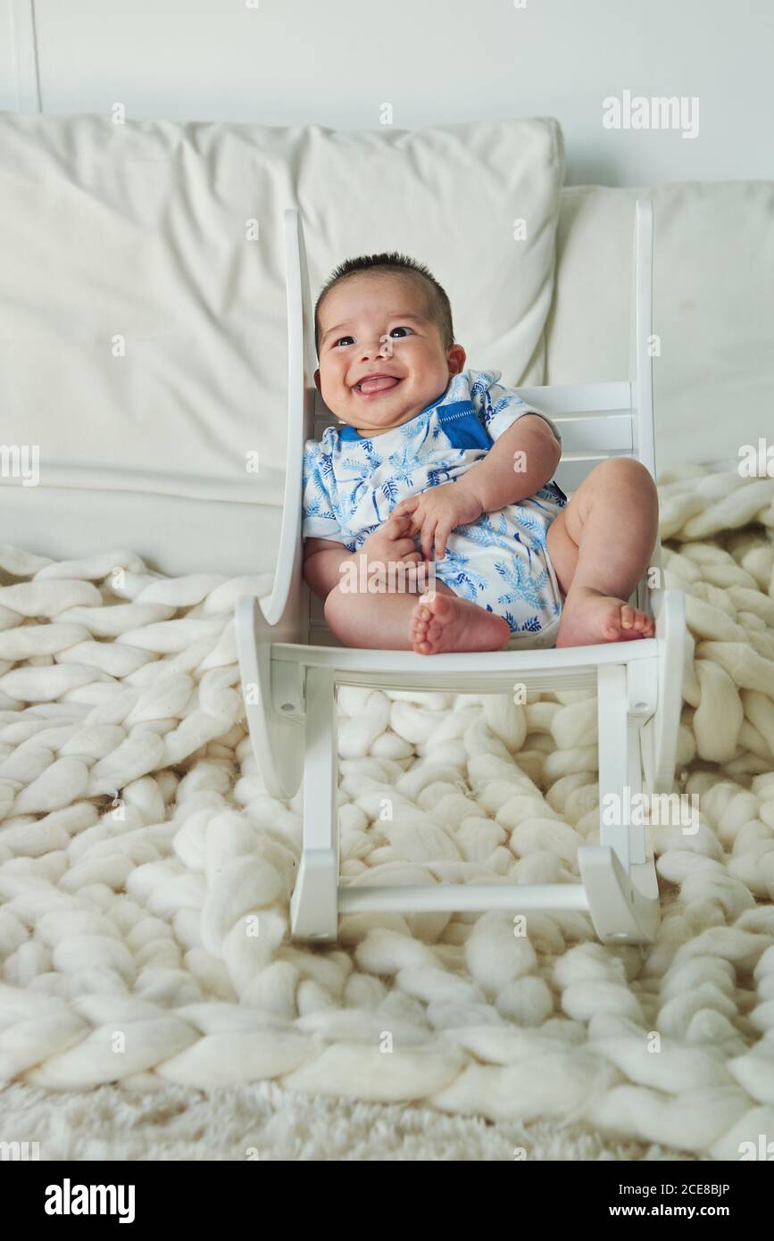 Little baby sitting on a rocker Stock Photo - Alamy