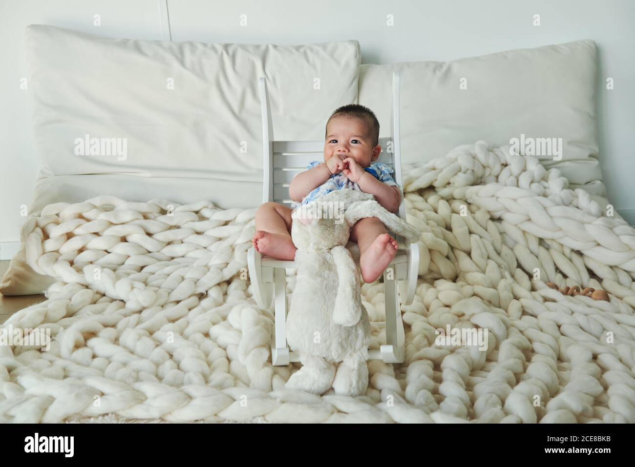 Little baby sitting on a rocker Stock Photo - Alamy