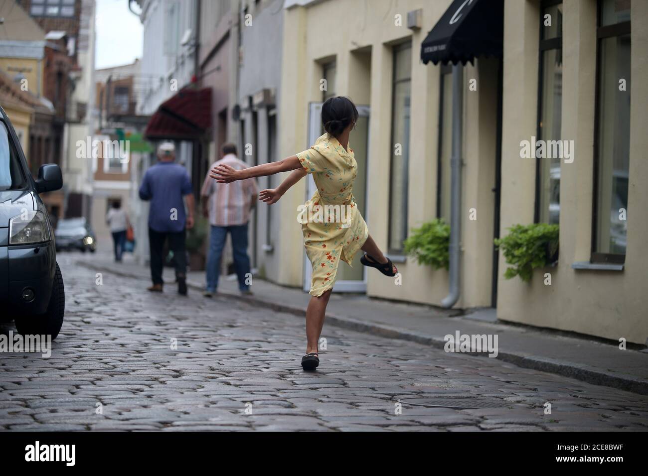 Solo dancer. A beautiful attractive woman jumping one dance down the ...