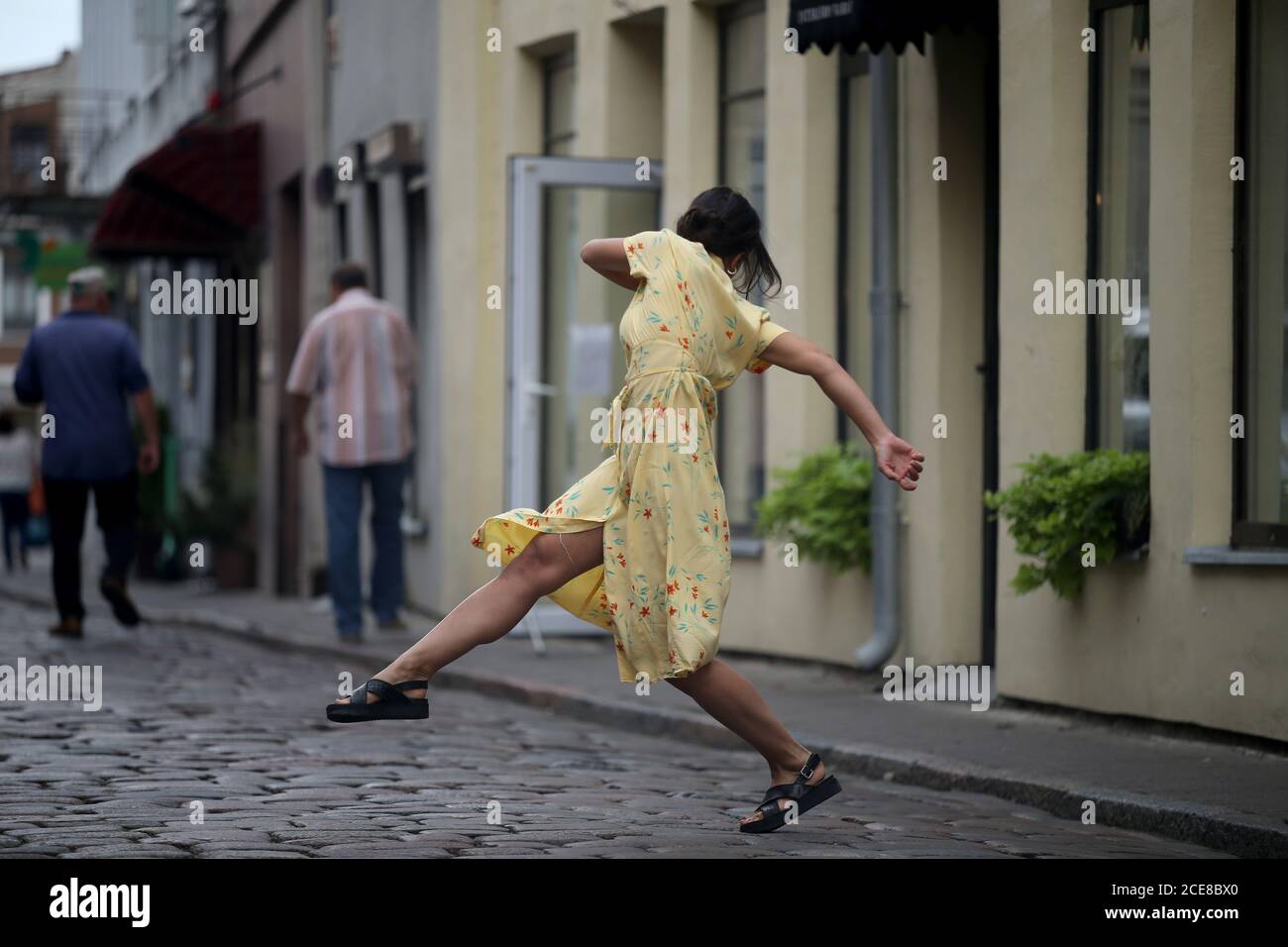 Solo dancer. A beautiful attractive woman jumping one dance down the ...