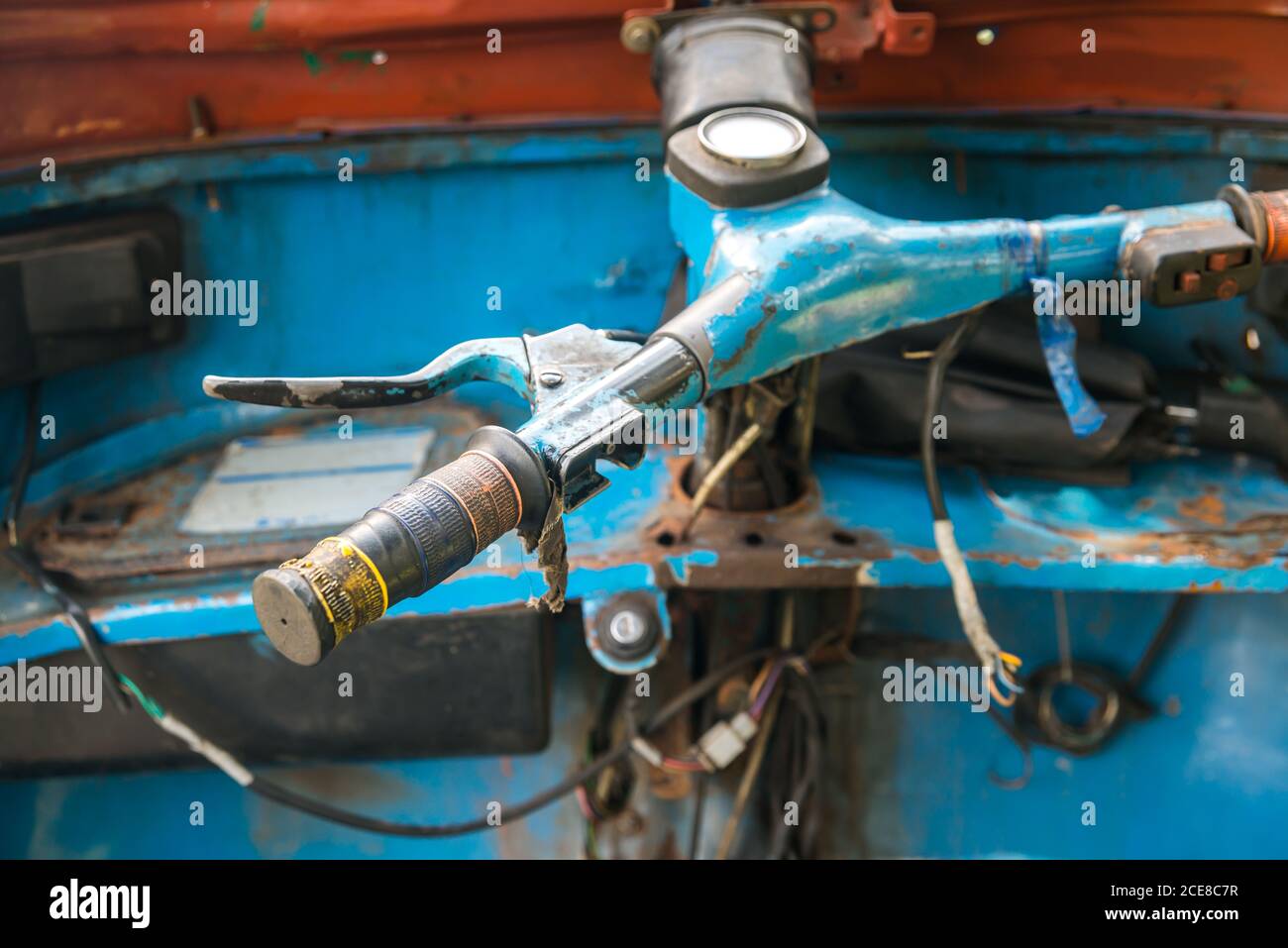Interior of automotive rickshaw with weathered handle bars made of ...