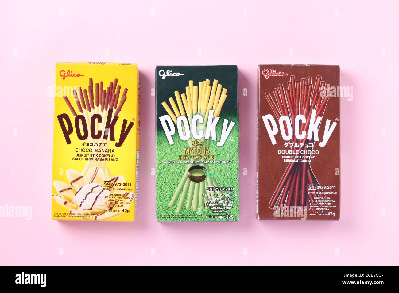 Pocky brand with banana, chocolate and matcha sticks on pink background ...